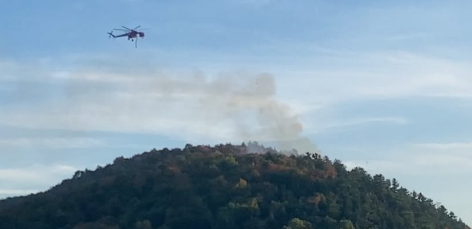 Firefighters battle mountaintop blaze, rescue injured driver from fiery ...